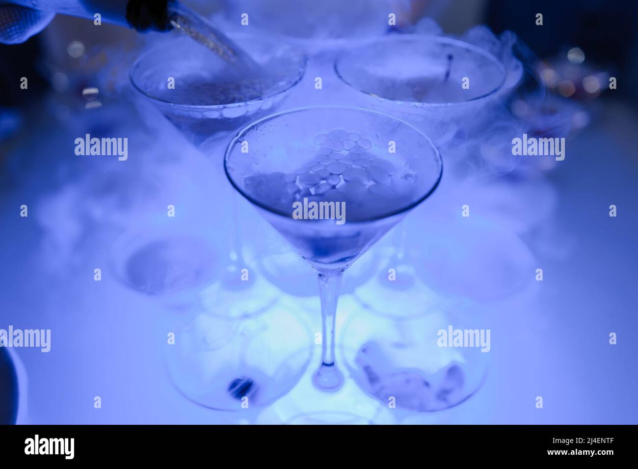 Glasses of champagne with dry ice. Champagne slide. Pyramid of ...