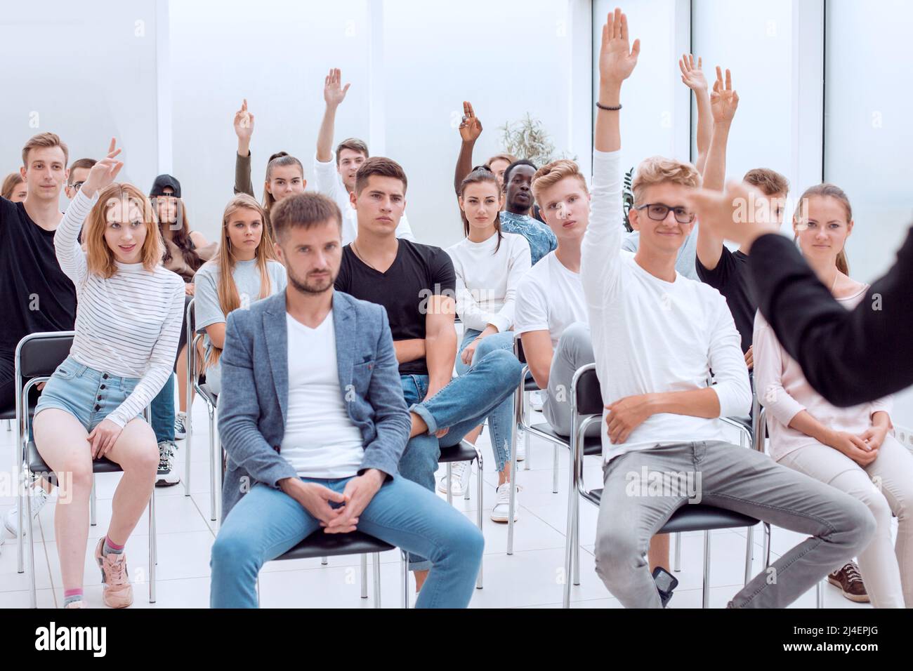 female speaker answers questions from the audience Stock Photo - Alamy