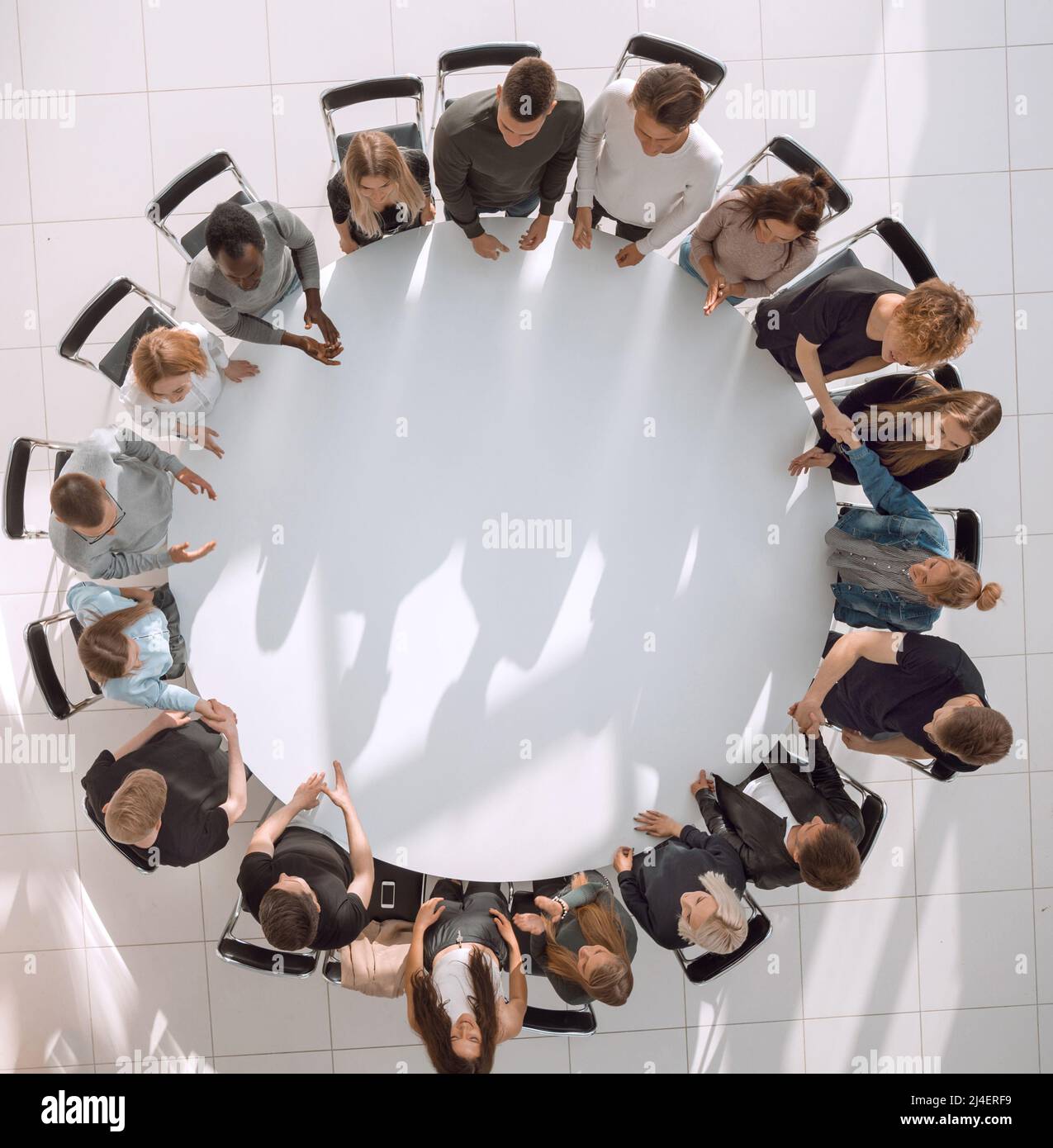 group of diverse young people at a round table meeting Stock Photo - Alamy