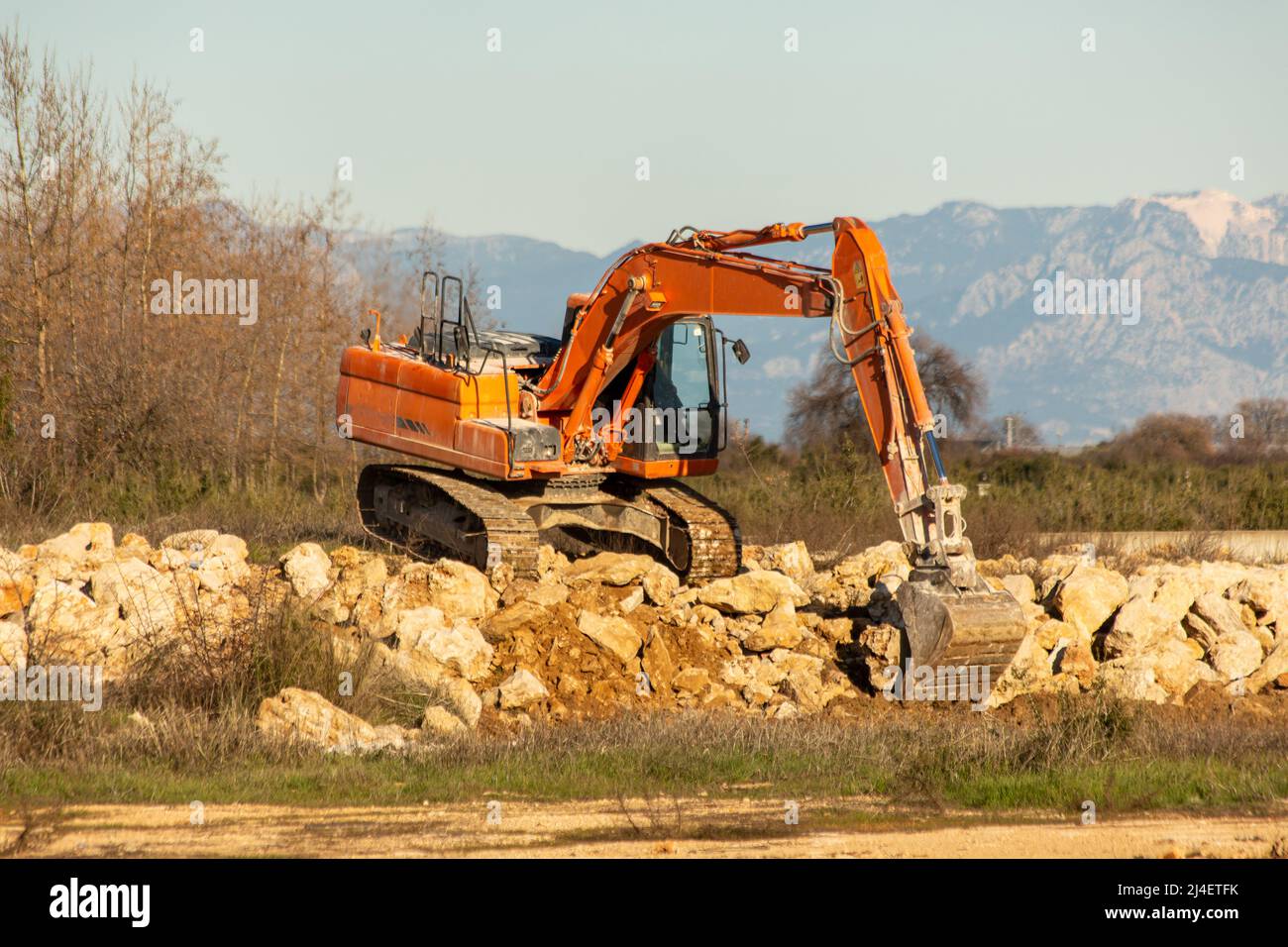 Backhoe moving piles gravel hi-res stock photography and images - Alamy