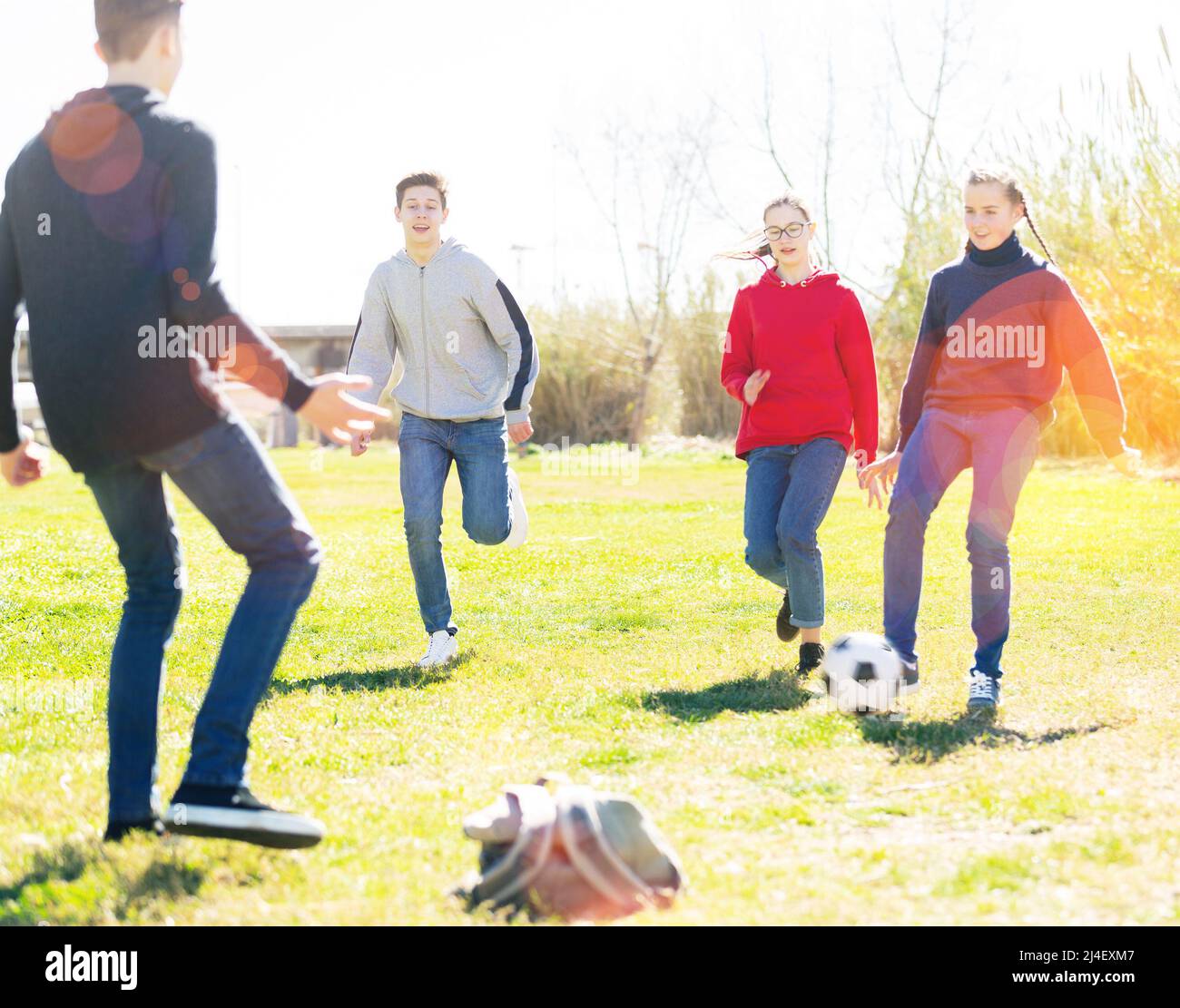 Teenagers play football with excitement Stock Photo - Alamy