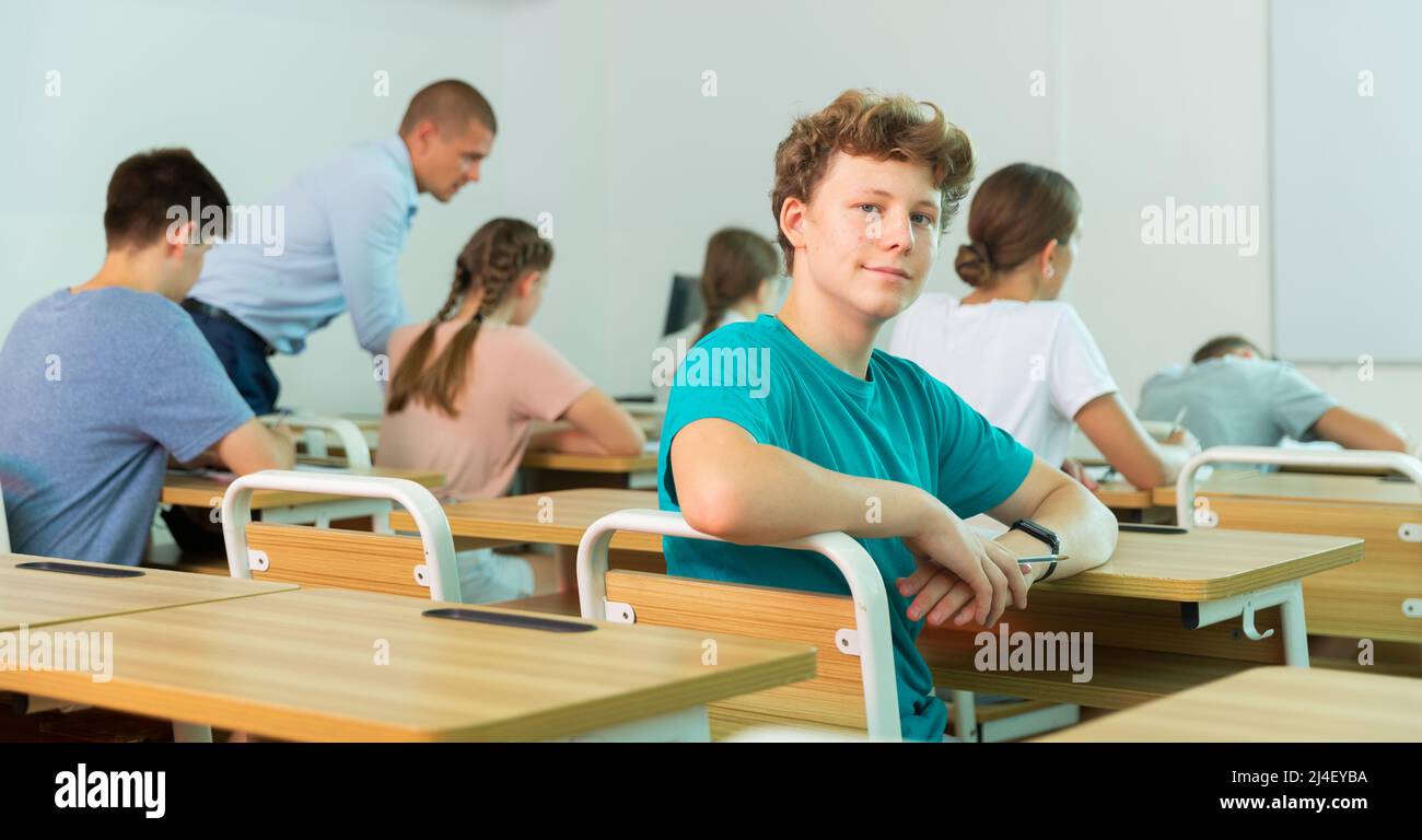 Teenager boy sitting in class room Stock Photo - Alamy