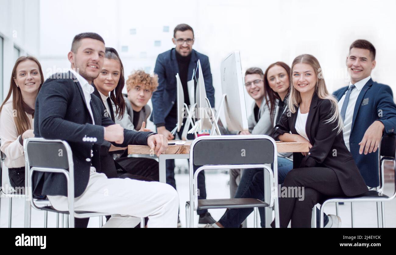 large group of employees sitting at office Desk Stock Photo - Alamy