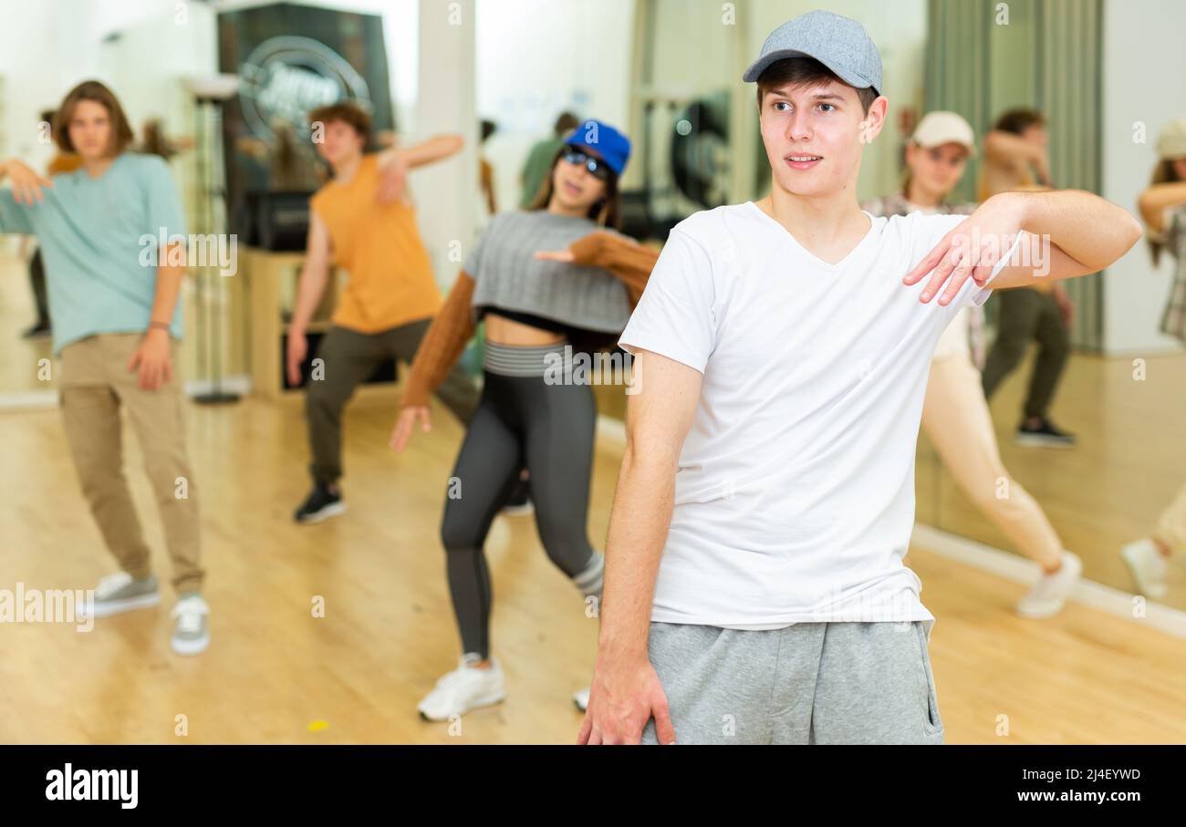 Teenage boy practicing hip-hop movements with group in studio Stock ... Teenage boy practicing hip-hop movements with group in studio Stock ...