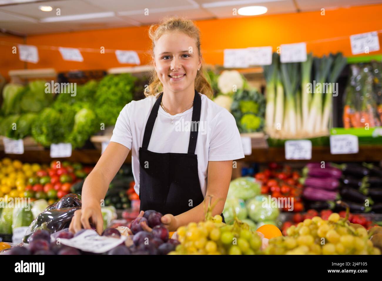 Teenage girl at her first job in vegetable store Stock Photo - Alamy