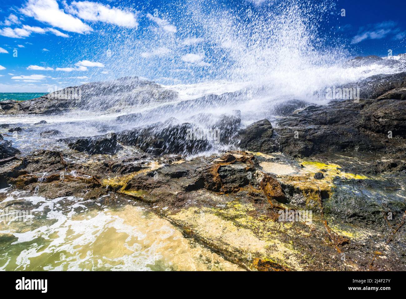 Water cascades over the rocks and the famous Champagne Pools on Fraser ...