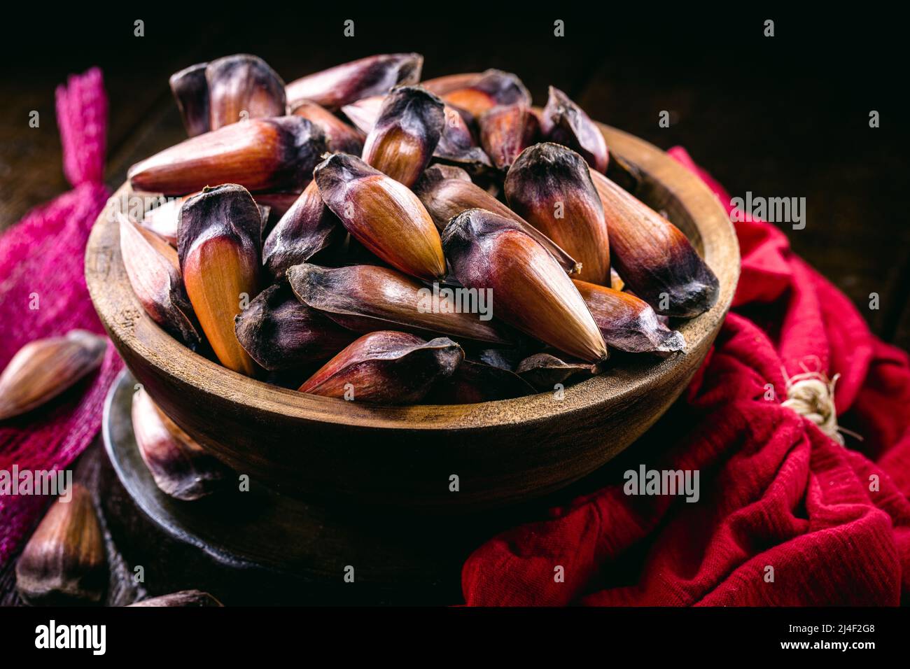 pine nuts in a rustic wooden bowl, traditional food of the Brazilian ...