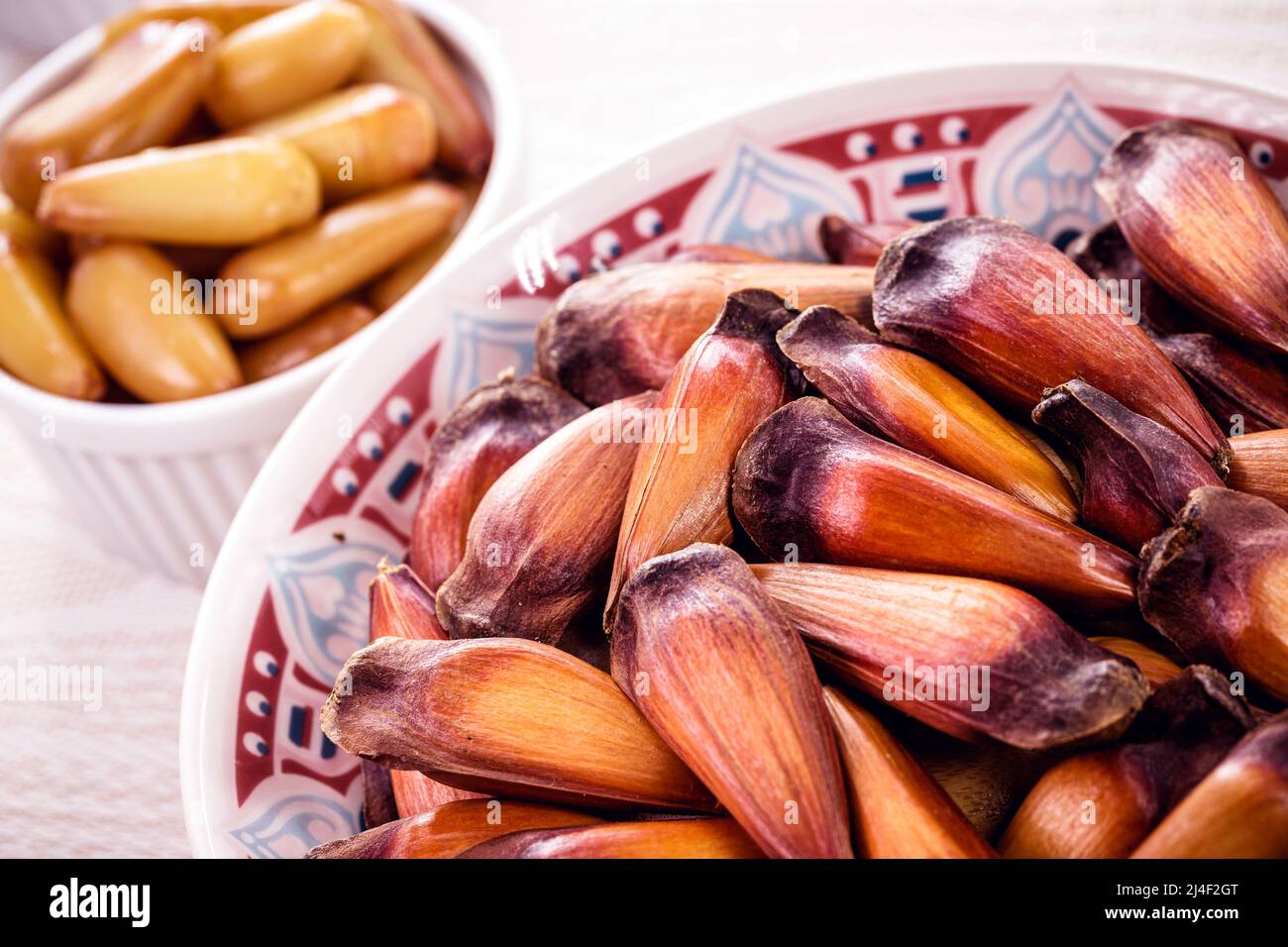 pine nuts in a rustic wooden bowl, traditional food of the Brazilian ...