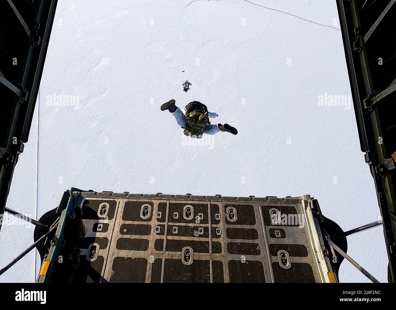 Naval Special Warfare members performs a high-altitude low-opening jump ...