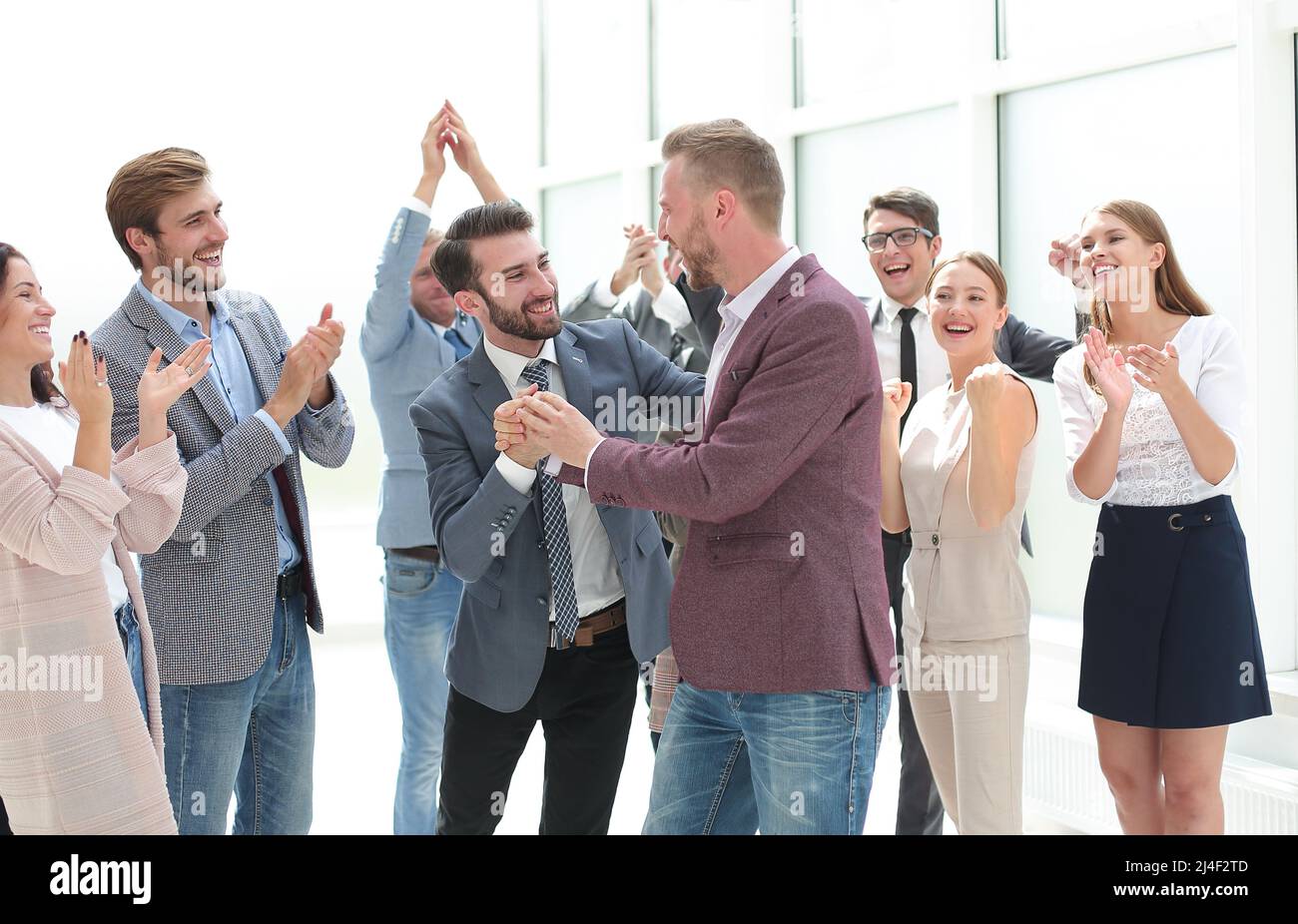 happy young business man accepting congratulations from his colleagues ...