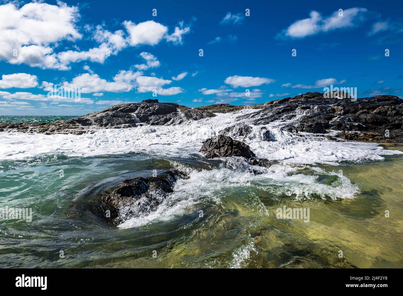Water cascades over the rocks and the famous Champagne Pools on Fraser ...