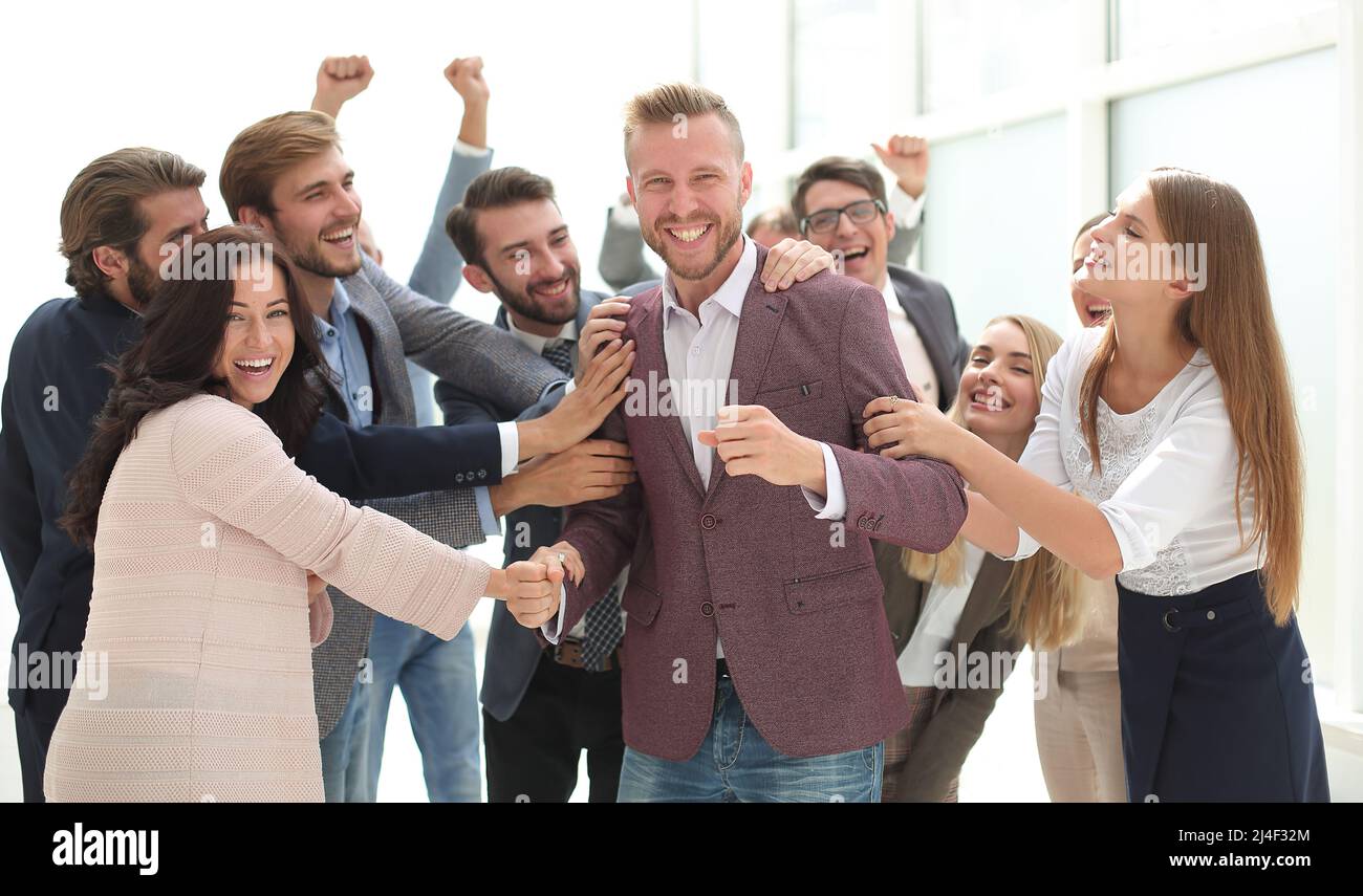 happy team of employees congratulating their colleague Stock Photo - Alamy