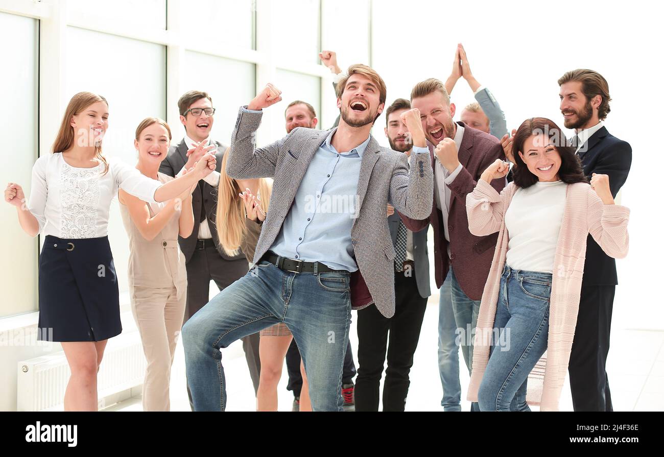 happy young businessman standing in front of his business team Stock ...