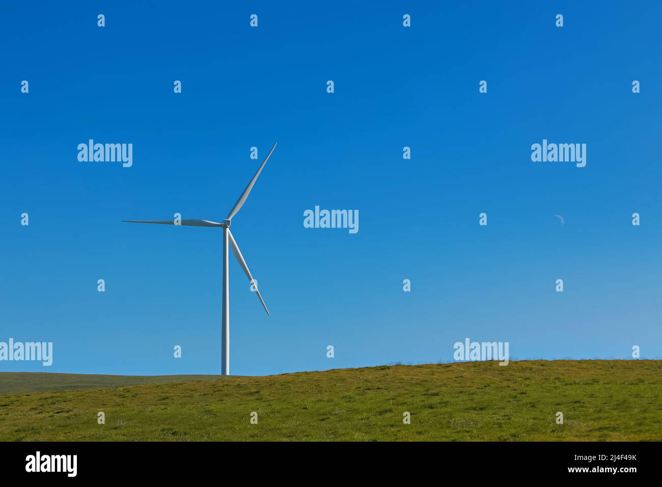 Electrical wind power mill over the blue sky. Alternative energy source ...
