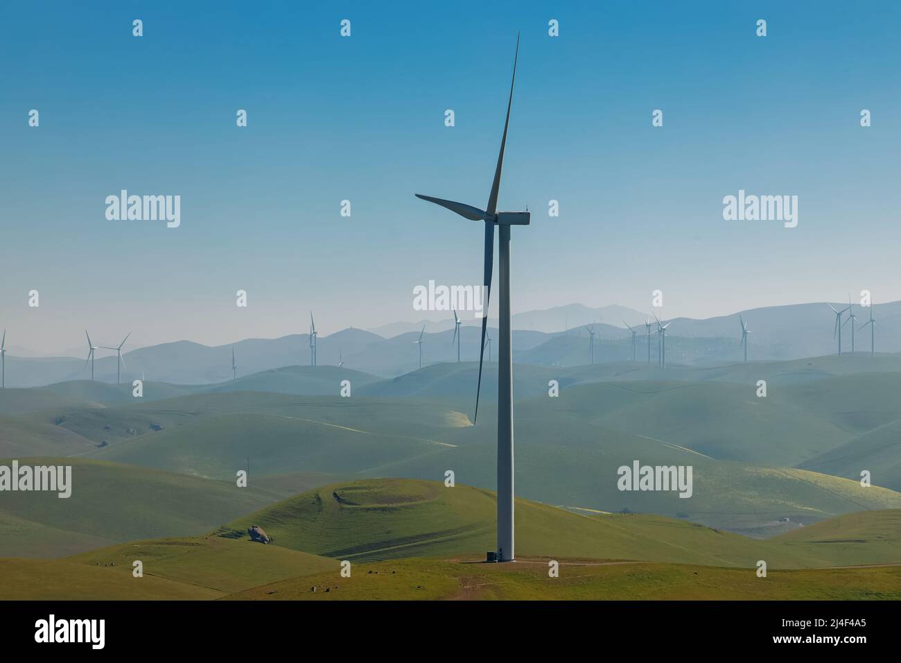 Electrical wind power mill on the green hill. Alternative energy source ...