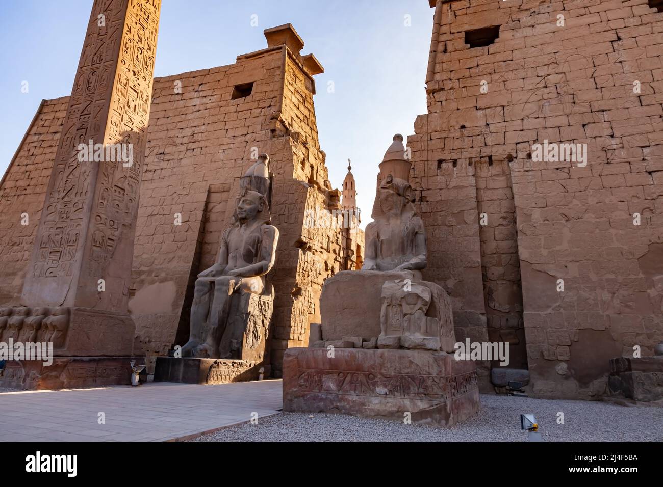 Statues of Pharaoh Ramses II and obelisk at the first pylon of Luxor ...