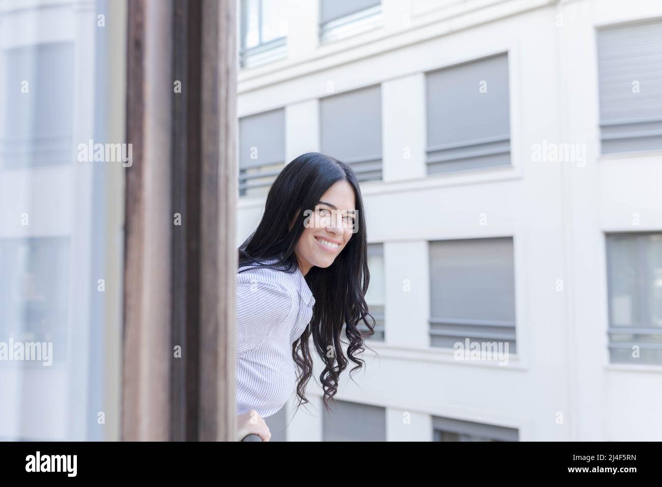 Happy rich young woman wear night robe stand at big window open lace ...