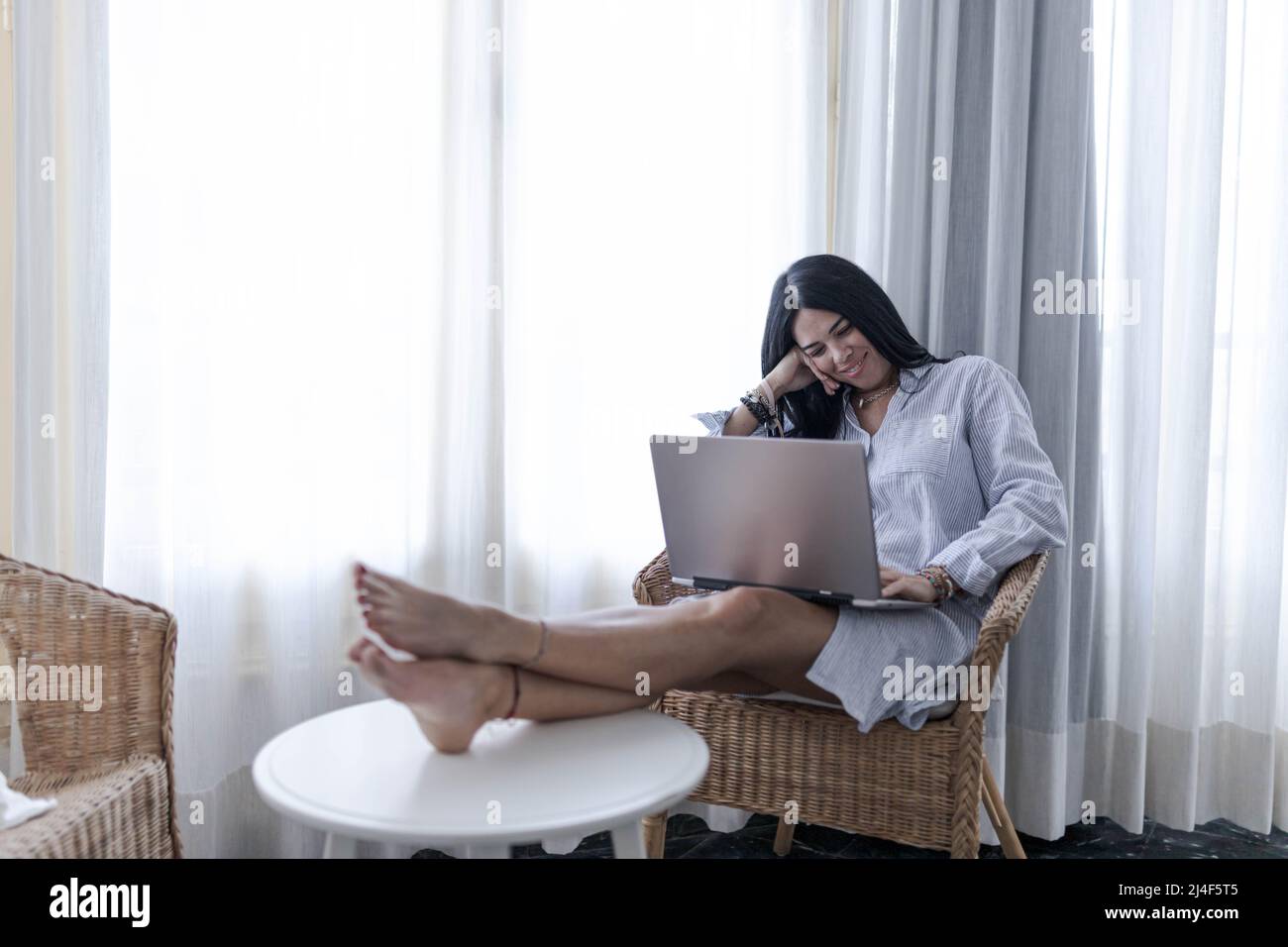 Happy rich young woman wear night robe stand at big window open lace ...