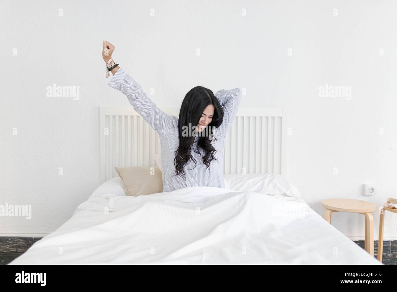 Happy rich young woman wear night robe stand at big window open lace ...