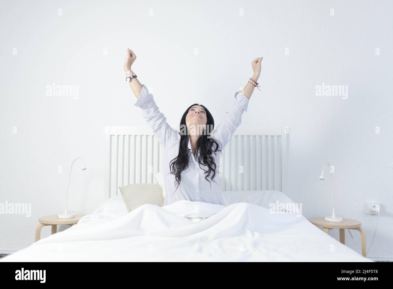 Happy rich young woman wear night robe stand at big window open lace ...