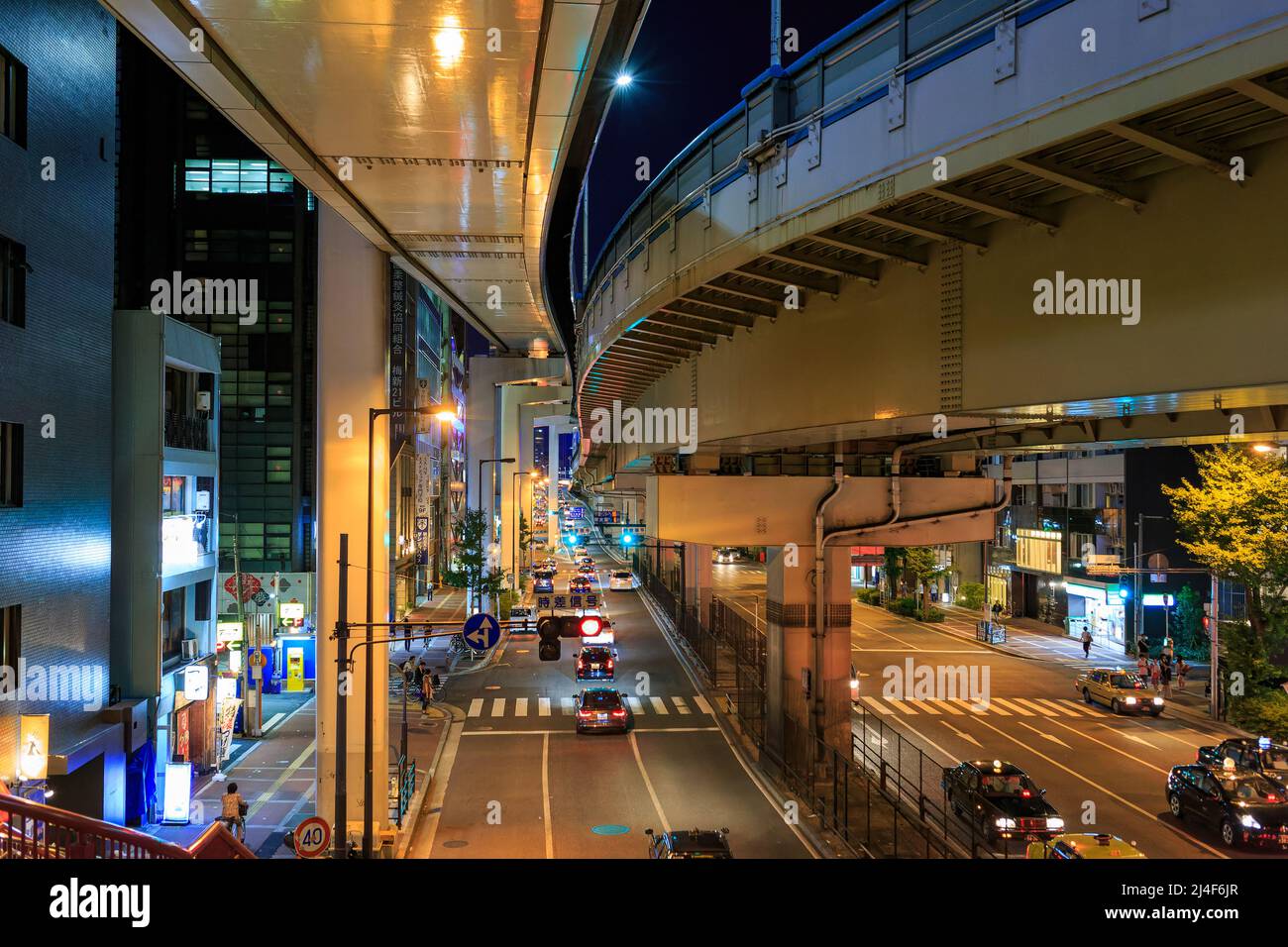 Overhead view of cars on wide road under elevated tracks at night Stock ...