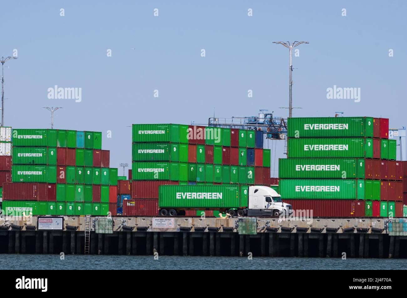 Stacked shipping containers and semi-truck shown at the Port of Los ... Stacked shipping containers and semi-truck shown at the Port of Los ...