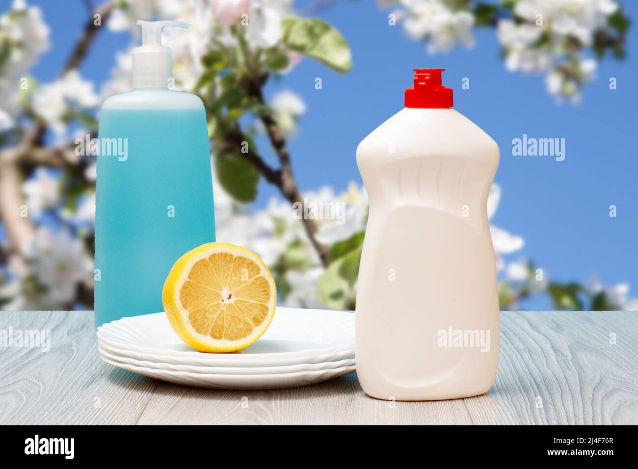 Plastic bottles of dishwashing liquid, glass and tile cleaner, clean ...