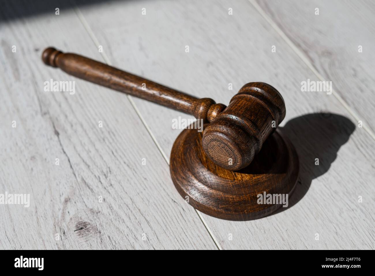 Wooden judicial gavel on a wooden laminate Stock Photo - Alamy
