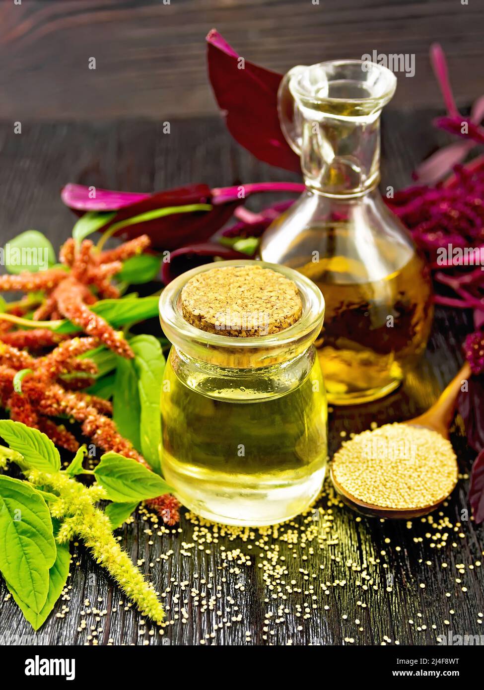 Amaranth oil in a glass jar and decanter, amaranth seeds, brown, green ...