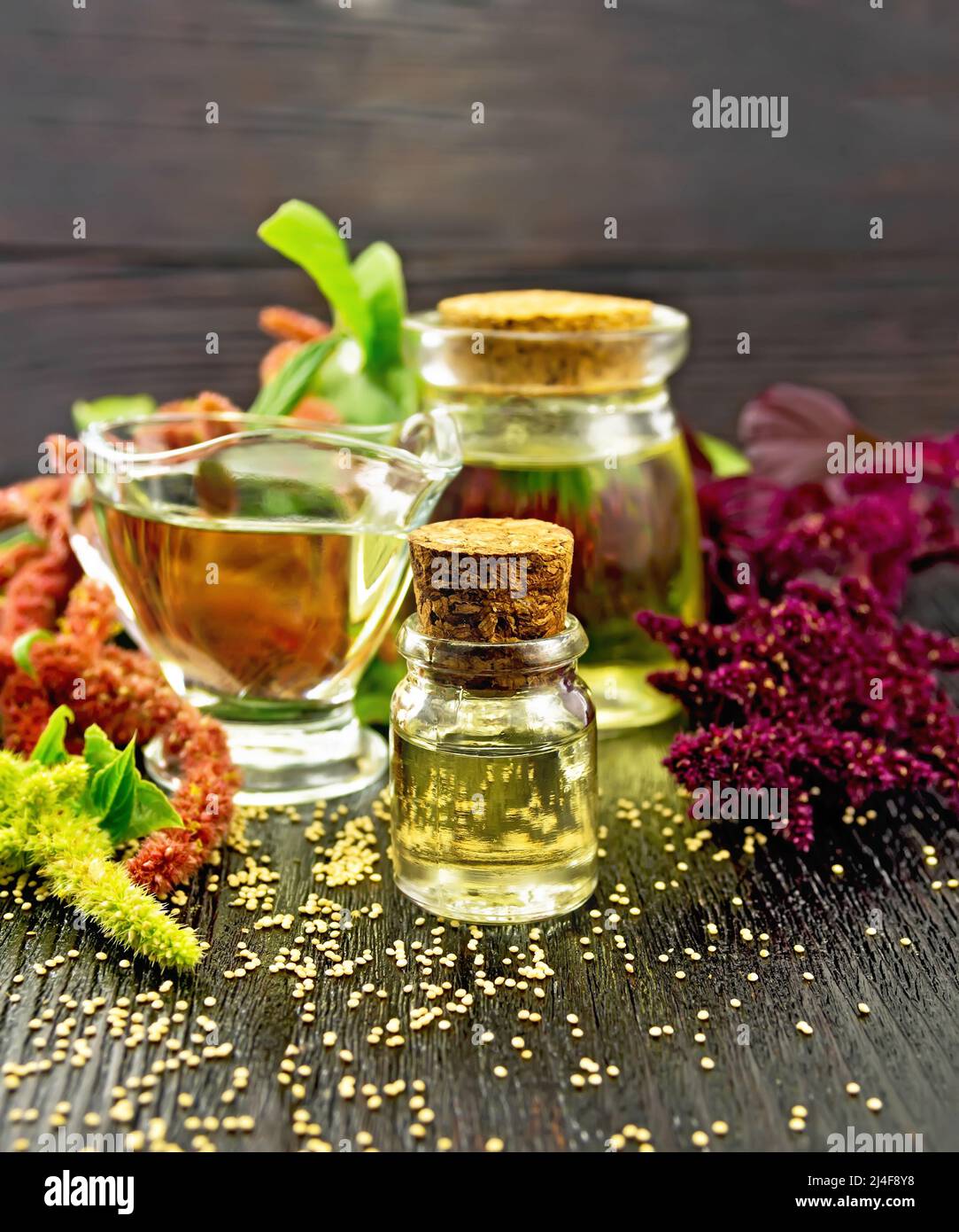 Amaranth oil in a glass bottle, gravy boat and jar, amaranth seeds ...