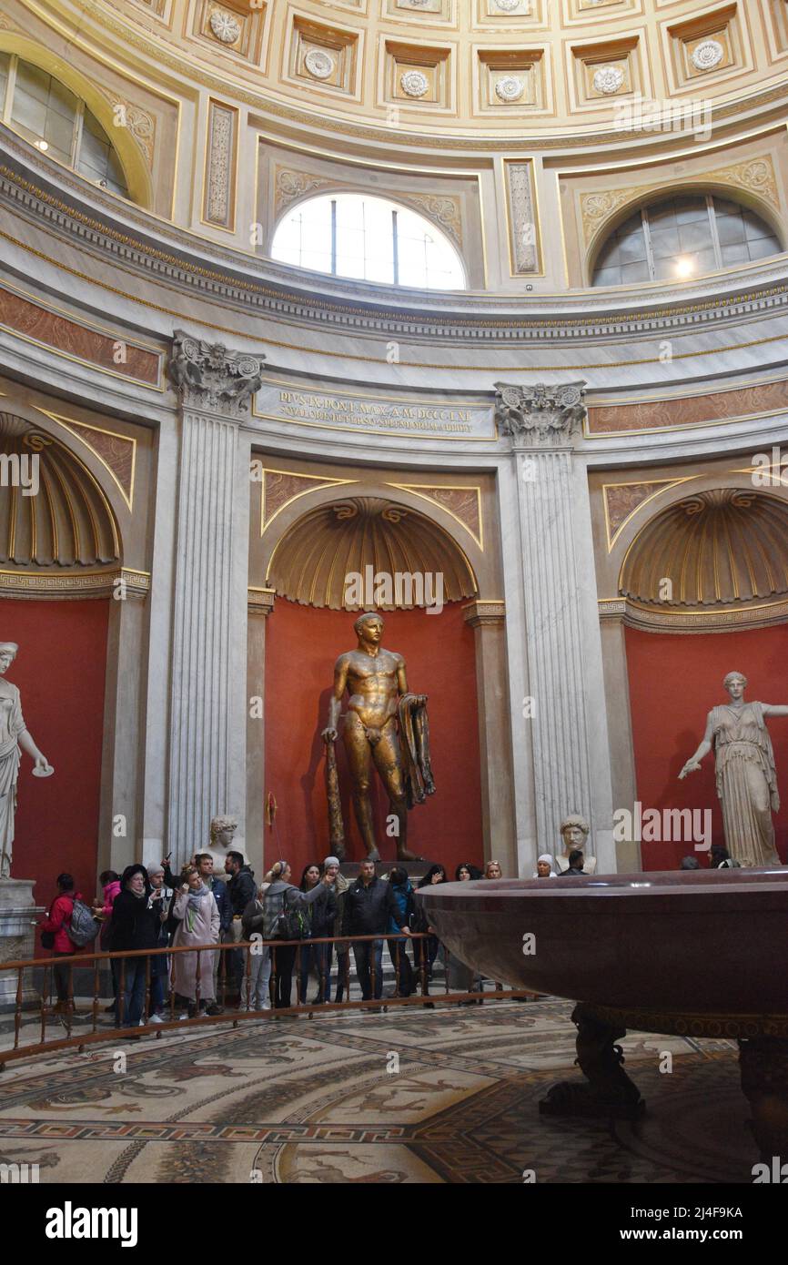 Tourists viewing the ancient statues in the Sala Rotonda of the Vatican ...