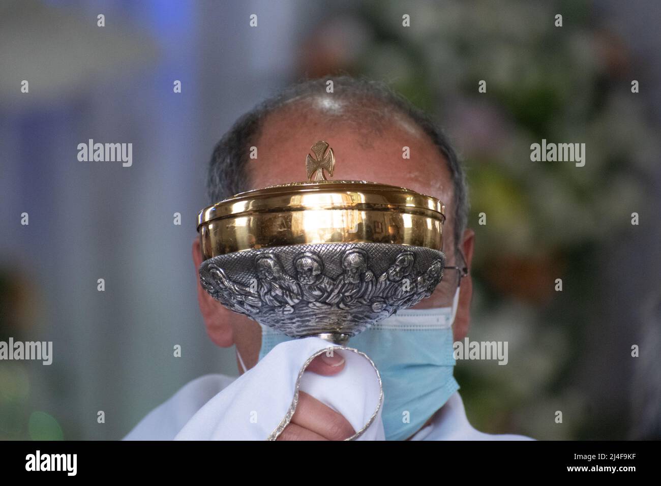 People attend the Sacrament of Eucharist Mass during the holy week ...