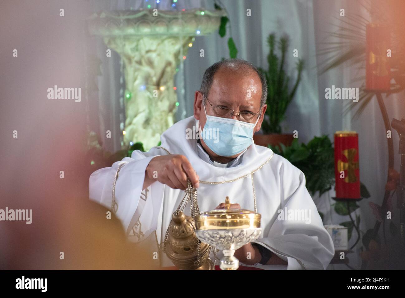 People attend the Sacrament of Eucharist Mass during the holy week ...