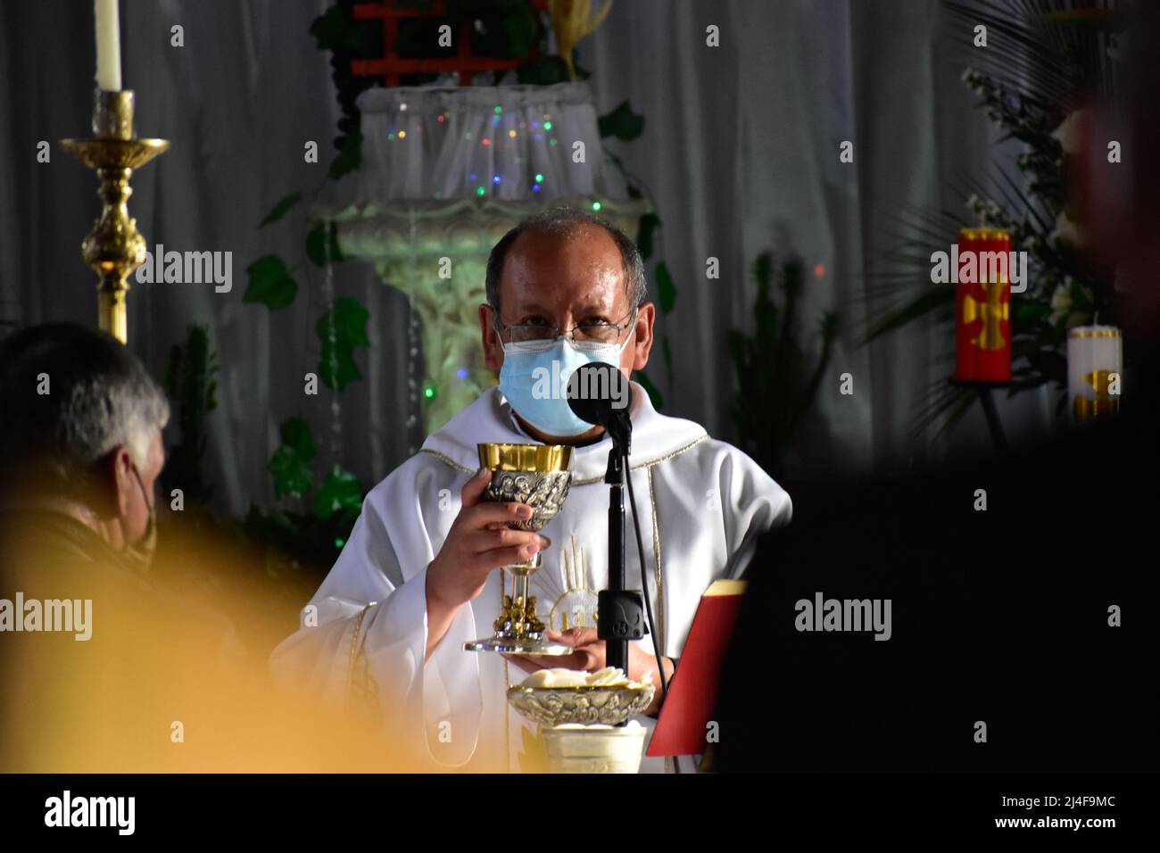 People attend the Sacrament of Eucharist Mass during the holy week ...