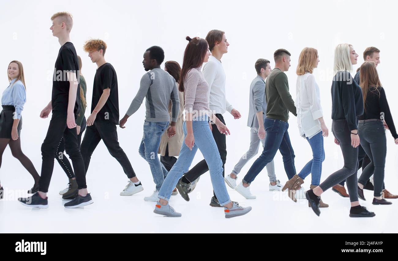 in full growth. diverse young people walking in different directions ...