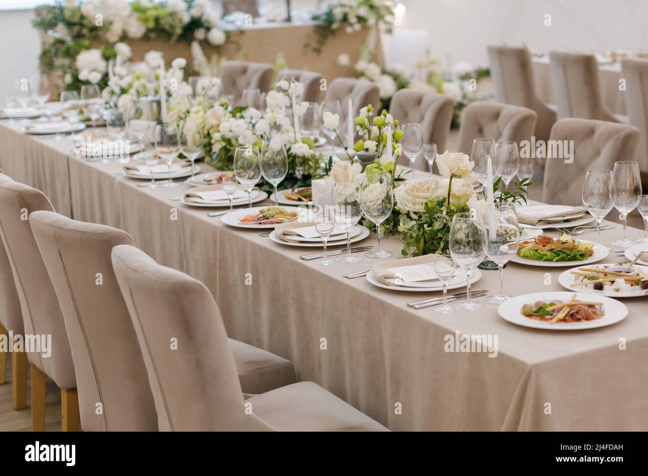 Tables setting at a luxury wedding. Table for guests. Dishes and drinks ...