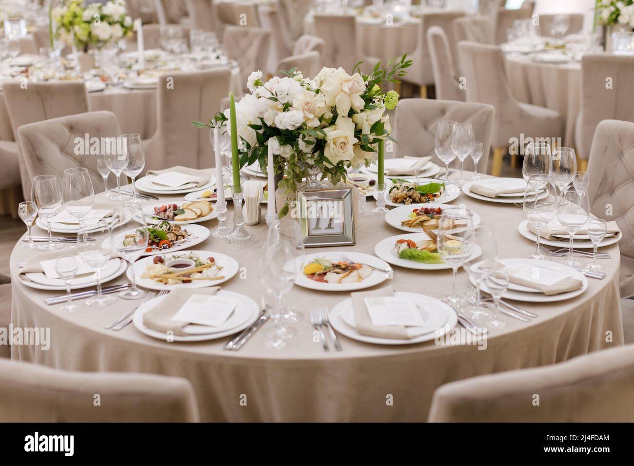 Tables setting at a luxury wedding. Table for guests. Dishes and drinks ...