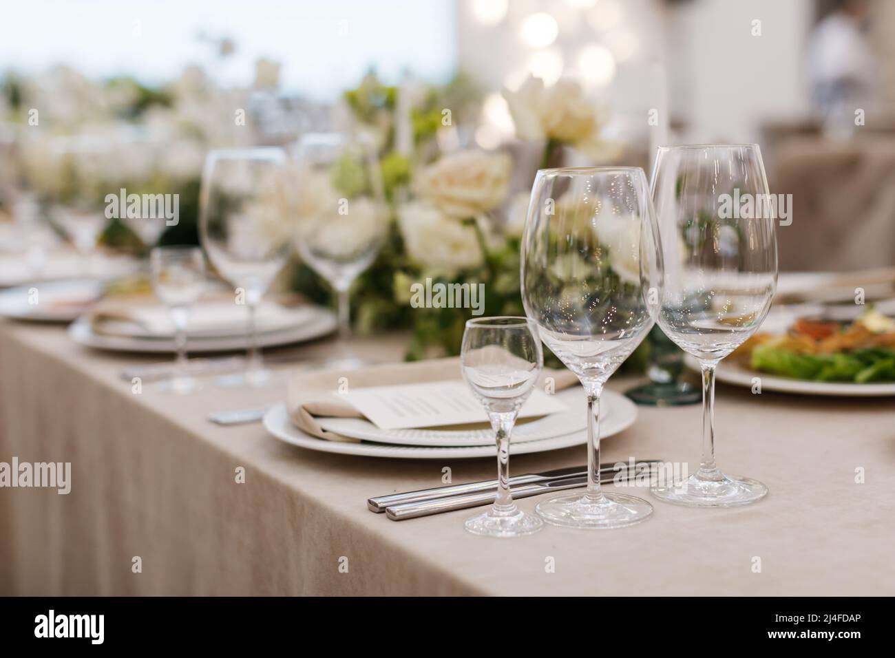 Tables setting at a luxury wedding. Table for guests. Dishes and drinks ...