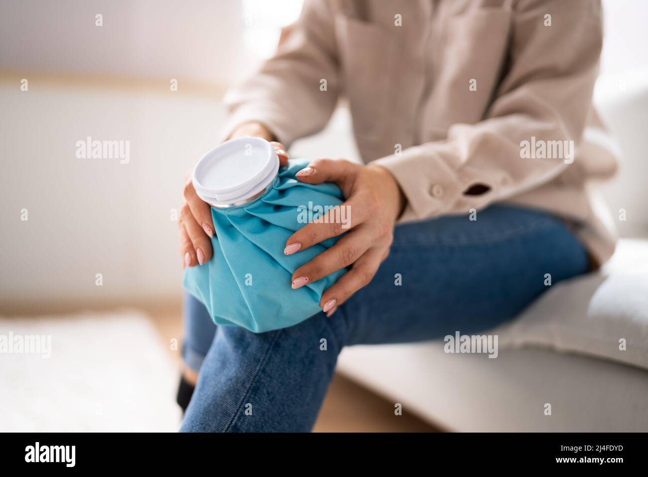 Applying Ice Pack To Knee Joint After Injury Stock Photo - Alamy