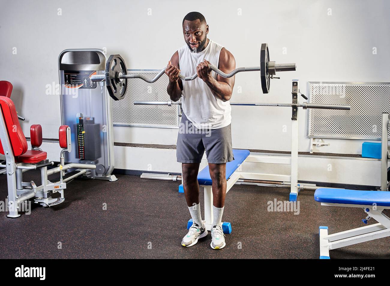 African-American man shakes biceps in the gym Stock Photo - Alamy