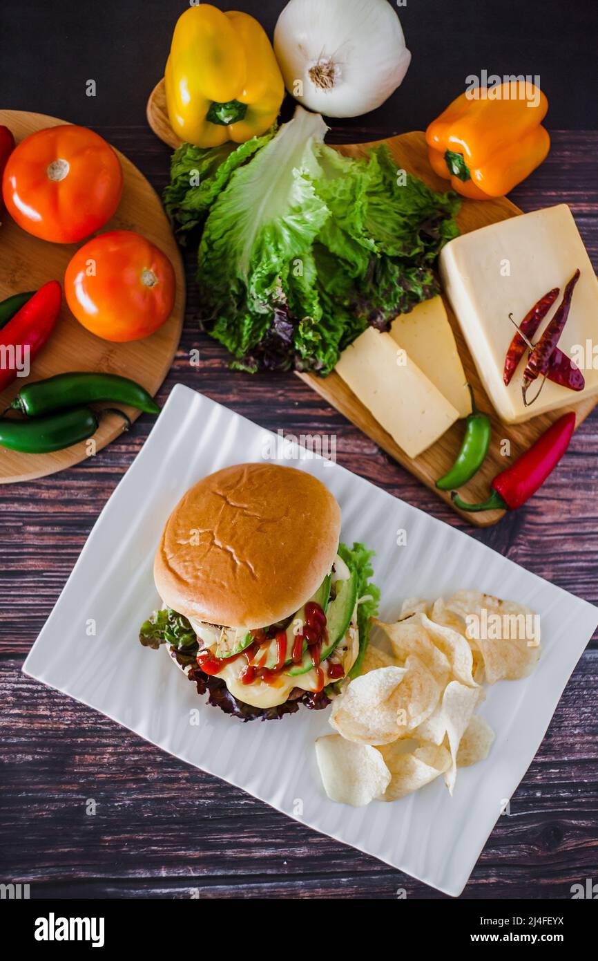 mexican burger with chips and avocado on table food with ingredients in ...