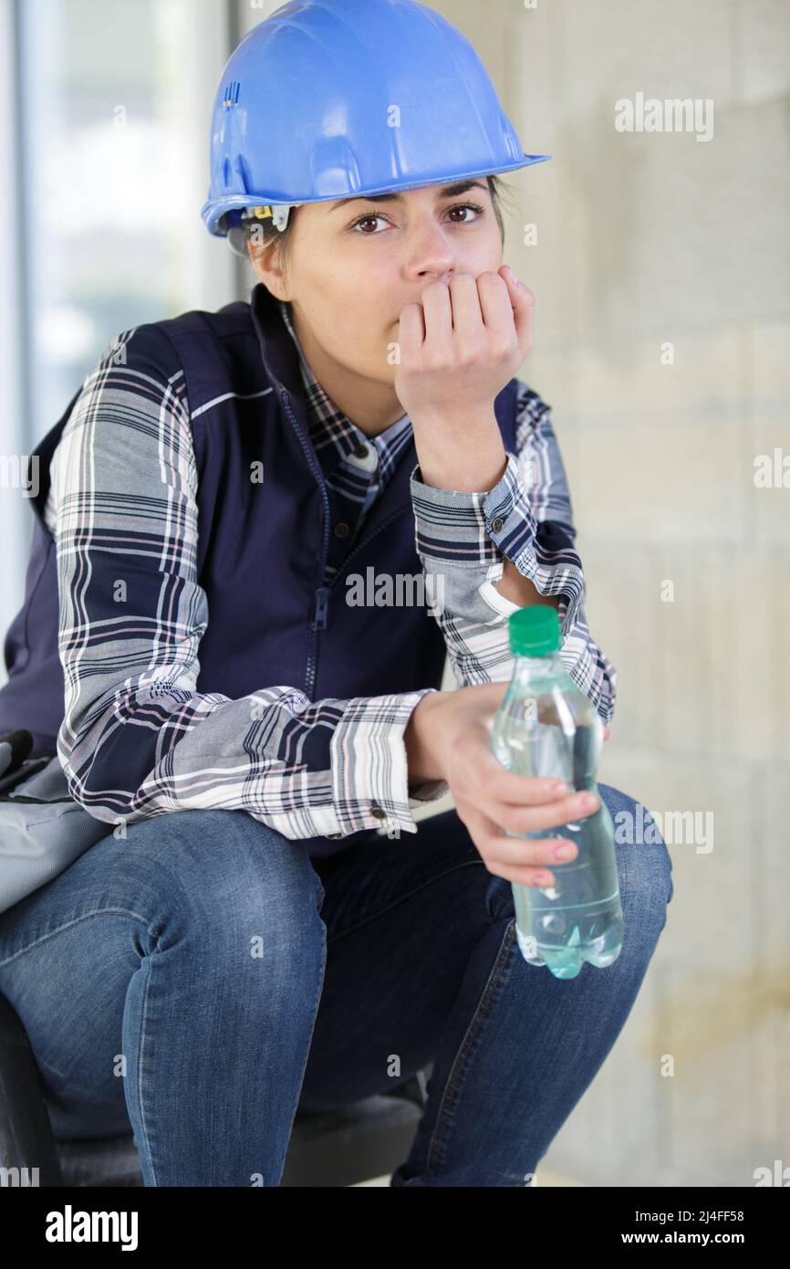 young woman constructor having a water break Stock Photo - Alamy