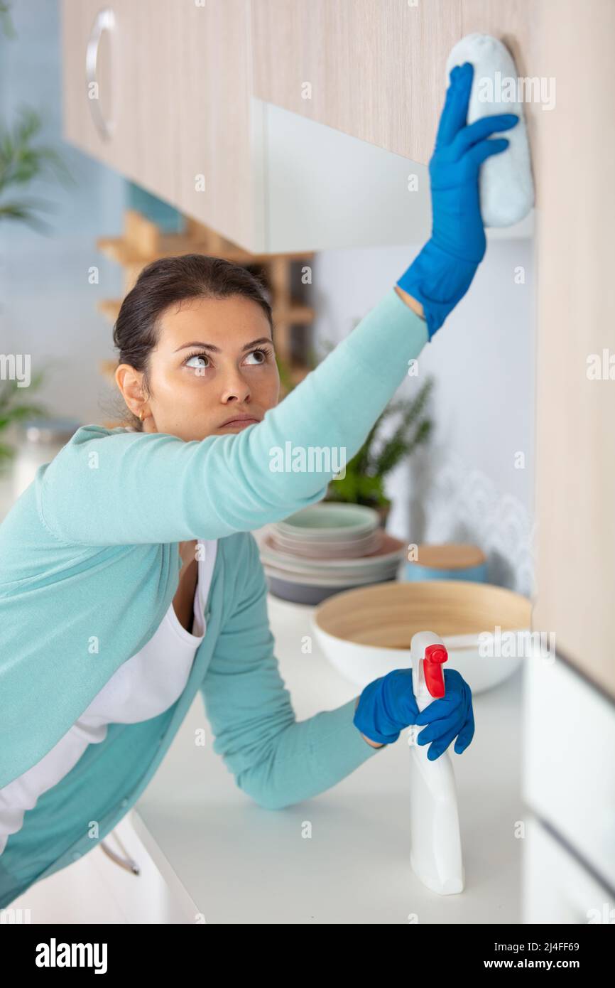 Woman scrubbing kitchen counter hi-res stock photography and images - Alamy