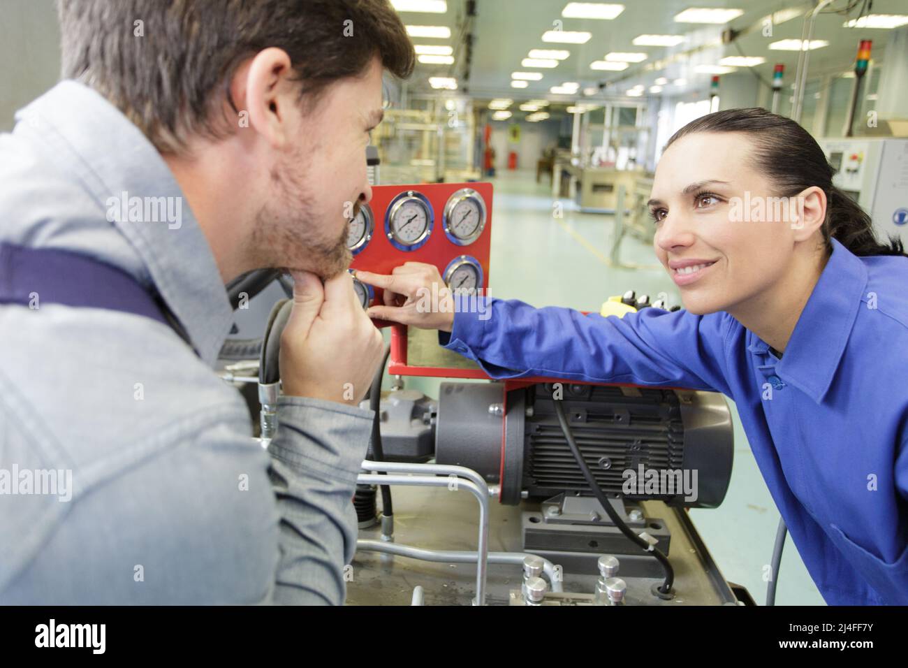 workers looking at gauges on factory equipment Stock Photo - Alamy