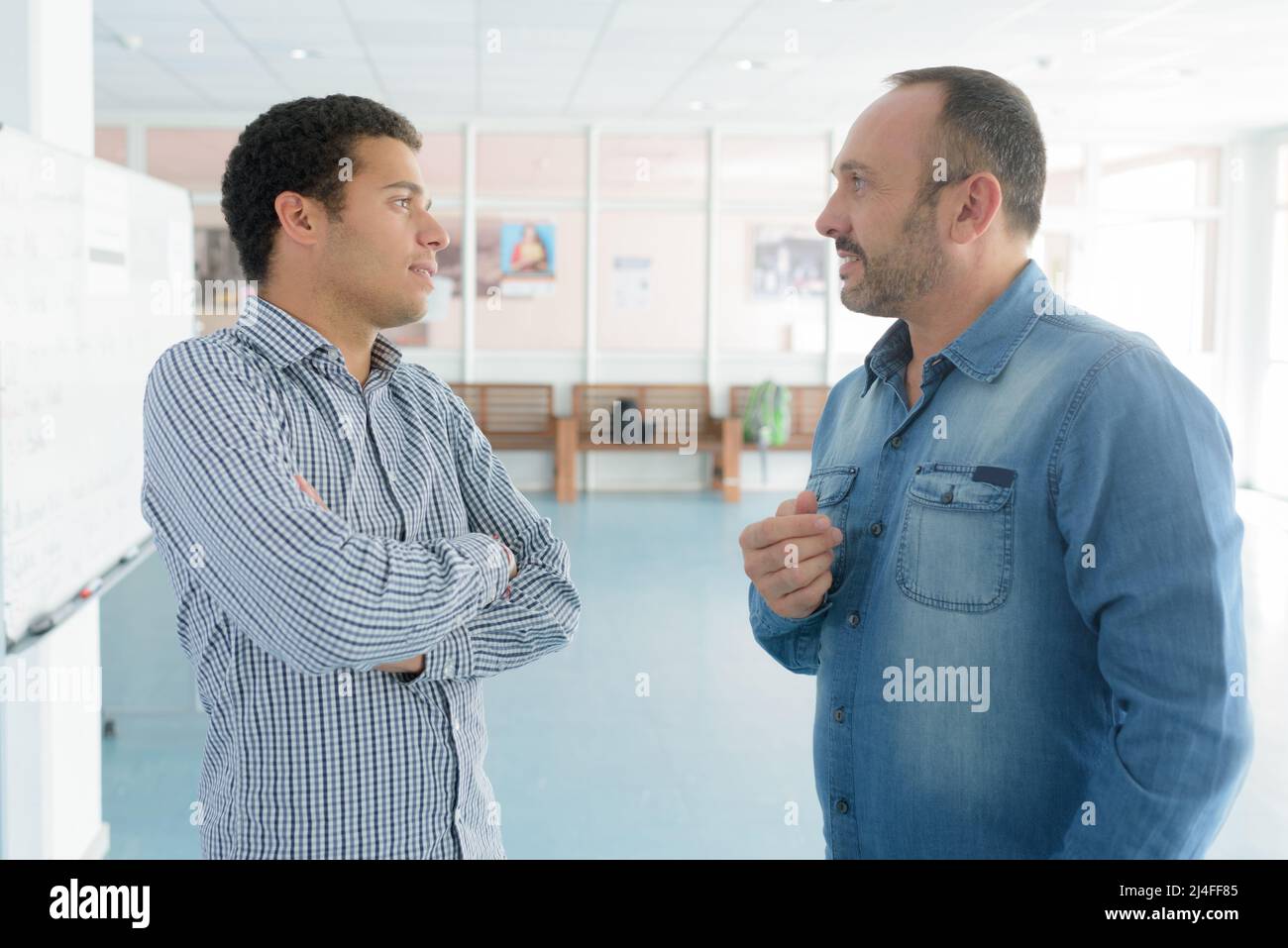 colleagues talking in the corridor Stock Photo - Alamy