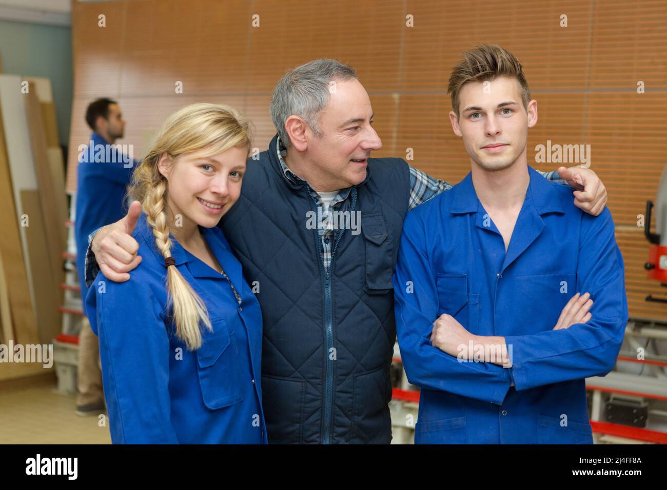 industrial trainer posing with apprentice with pride Stock Photo - Alamy