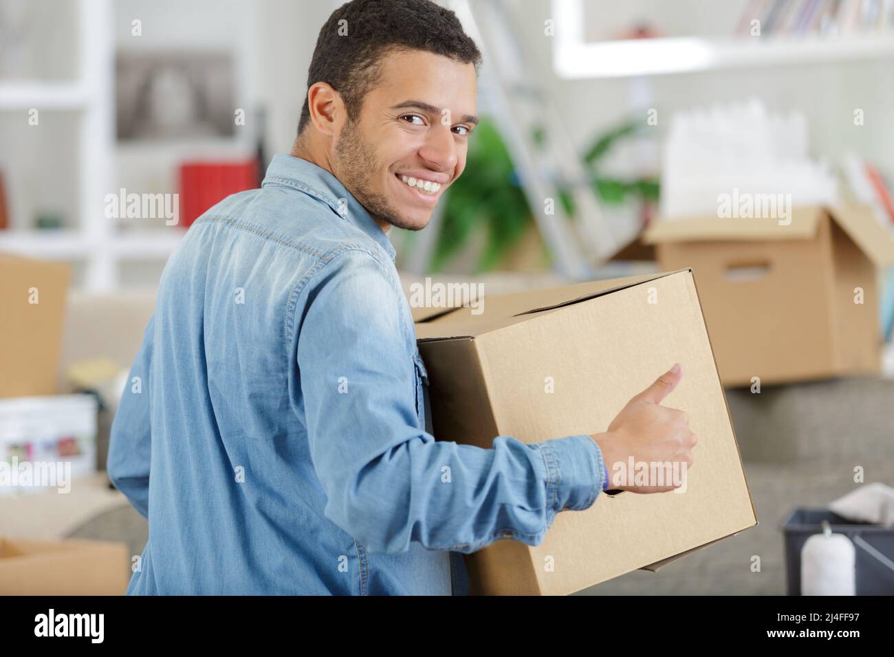 happy man carrying boxes ready for home renovation Stock Photo - Alamy