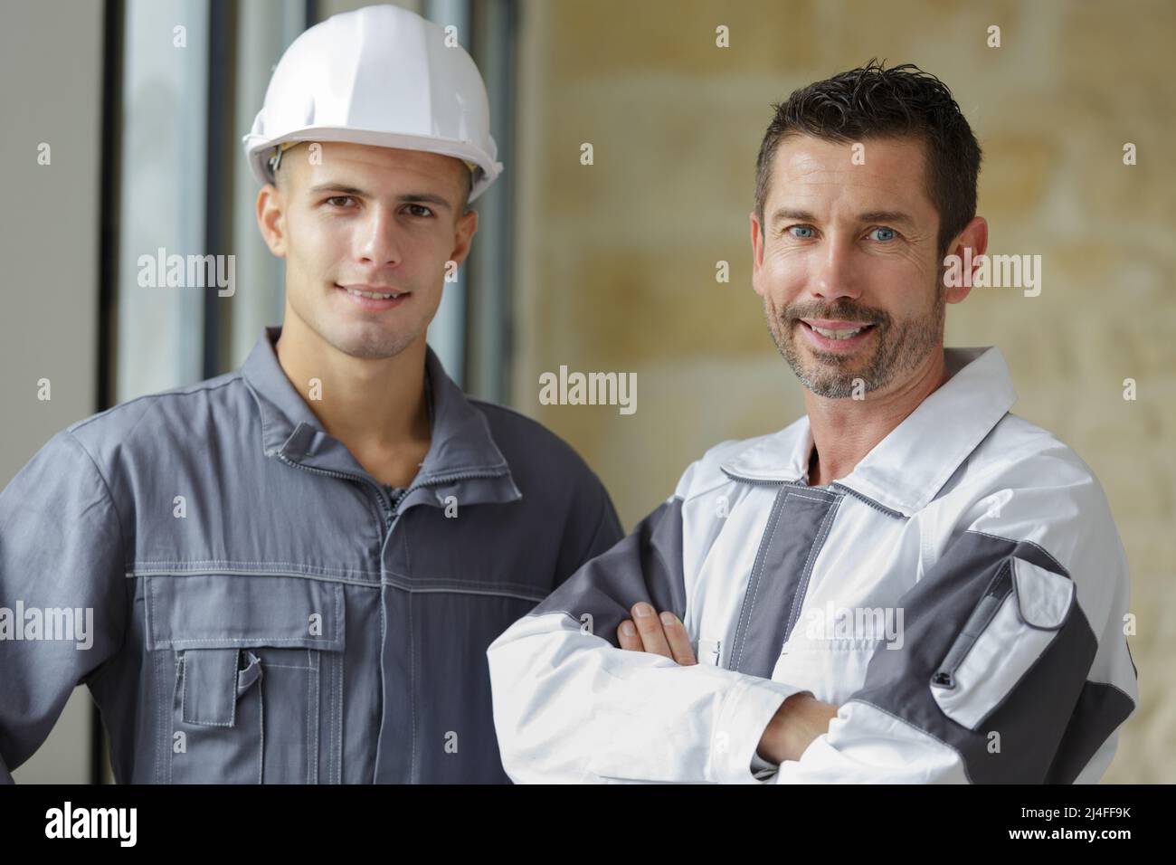 portrait of two construction workers wearing hard hats Stock Photo - Alamy