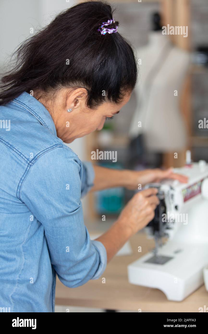 fashion designer sewing with sewing machine Stock Photo - Alamy