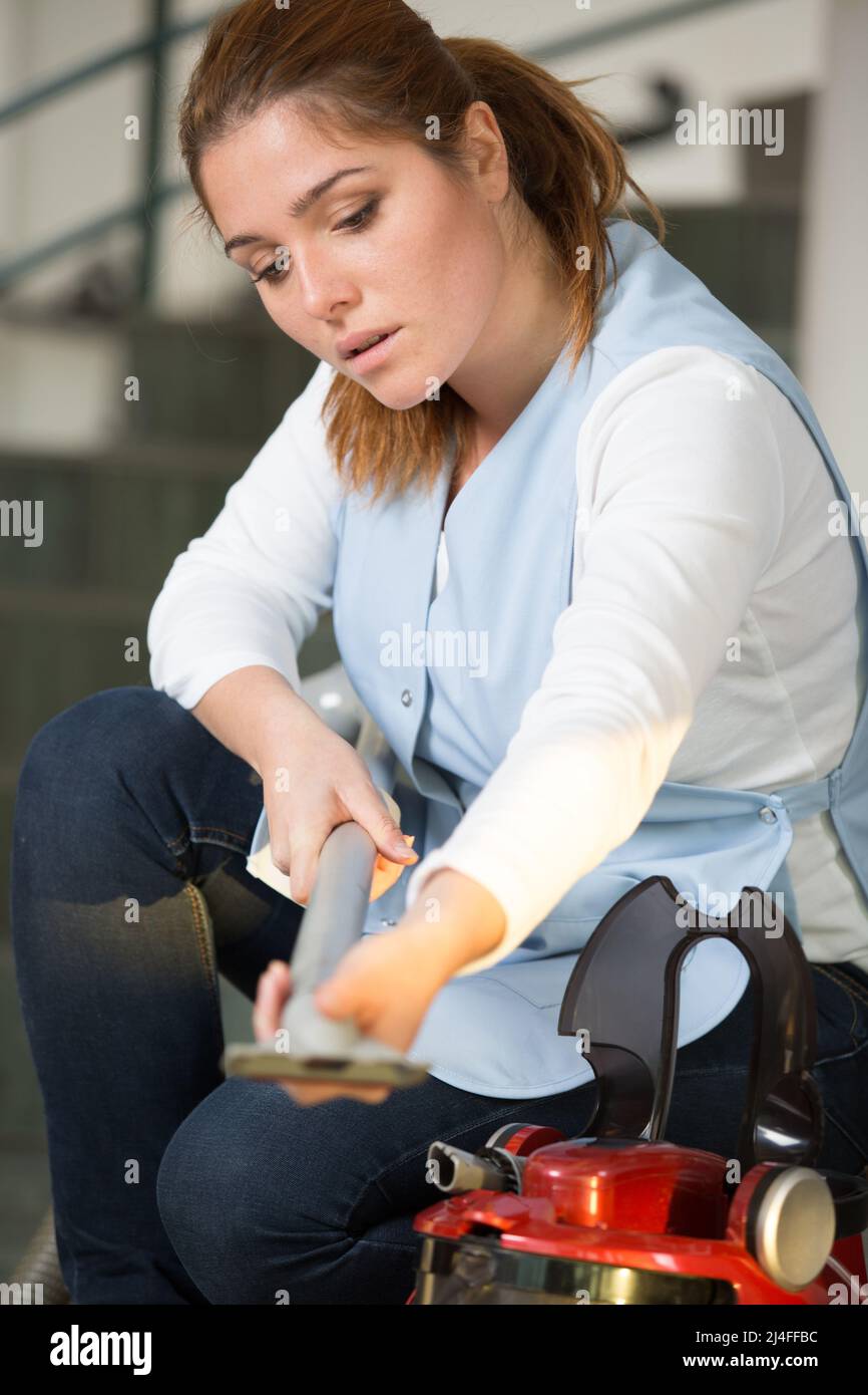 maid fitting hose on to vacuum cleaner Stock Photo - Alamy